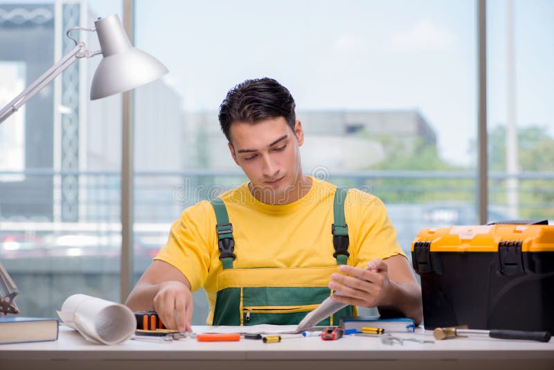 The Construction Worker Sitting at the Desk Stock Photo - Image of ...