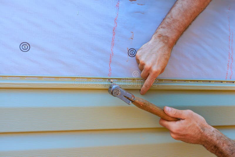 Hands Applying Finishing Touches To Exterior Wall during Home ...