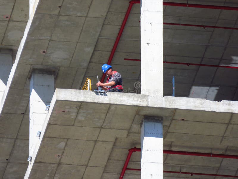 Construction Worker at Skyscraper Construction Site. Finishing of the ...