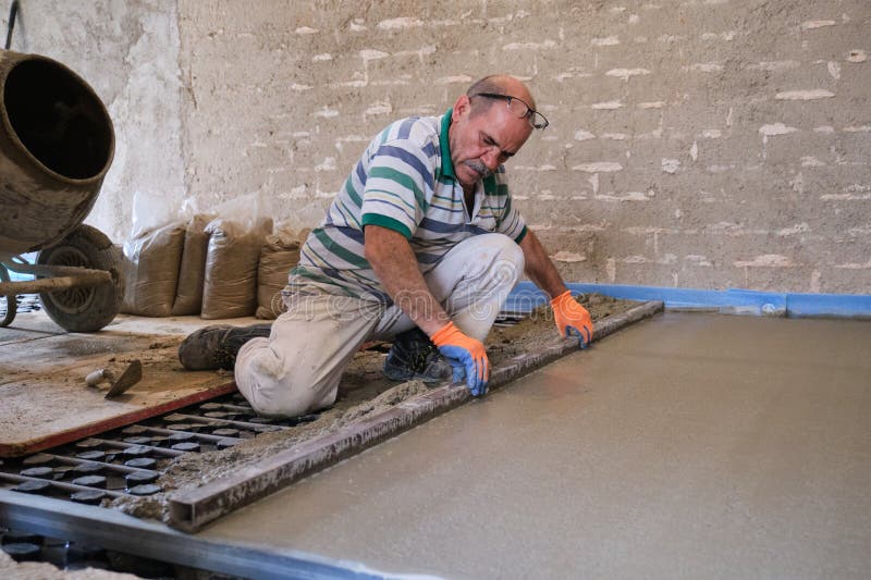 Construction Worker Smoothing Concrete Above the Radiant Underfloor ...