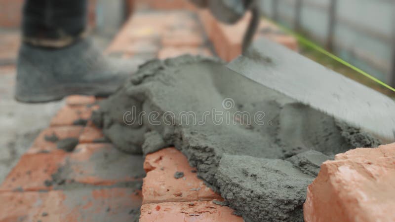 Construction Worker Spreading Mortar on Bricks, Worker Using a Trowel ...