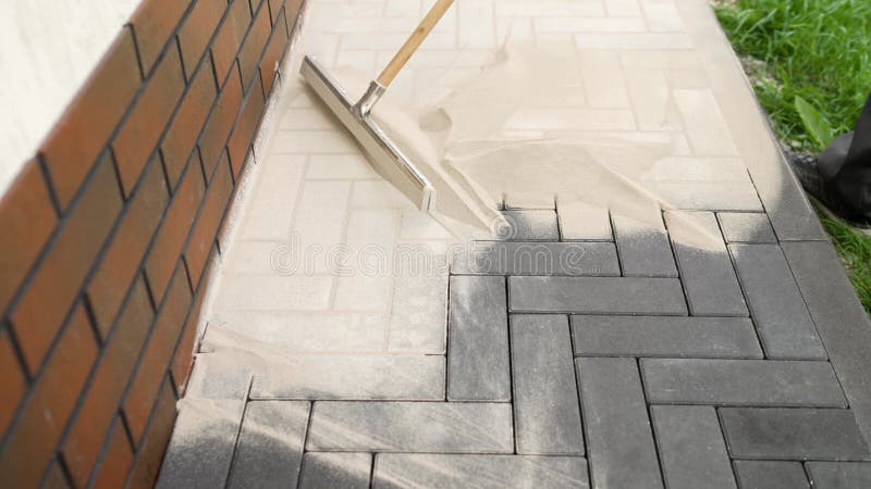 Construction Worker Spreading Sand on Paving Stones Stock Video - Video ...