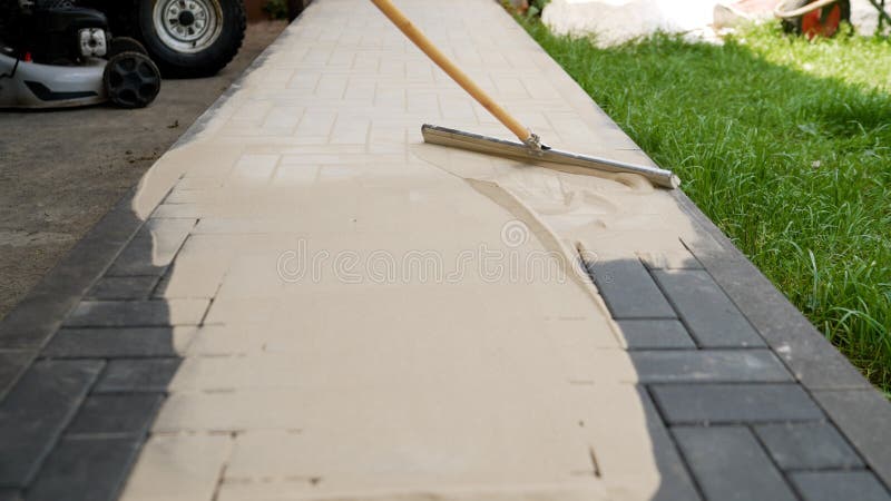 Construction Worker Spreading Sand on Paving Stones Stock Image - Image ...