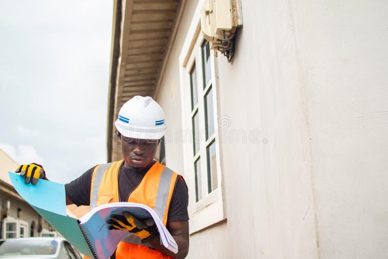Construction Worker is Standing Outside, Looking To the Map Stock Image ...