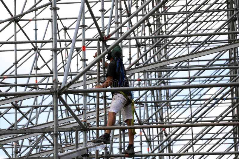 Construction Worker on Steel Scaffolding with Safety Equipment Outdoors ...