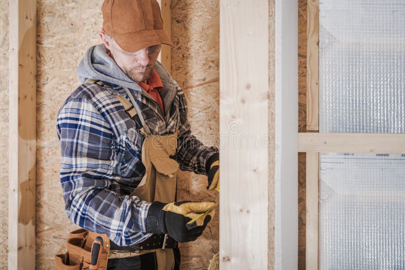 Construction Worker Taking Measurements Inside Newly Developed House ...