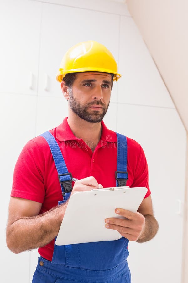 Construction Worker Taking Notes on Clipboard Stock Photo - Image of ...