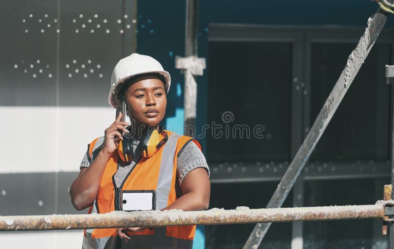 Construction Worker Talking on a Phone Call while Standing in a ...