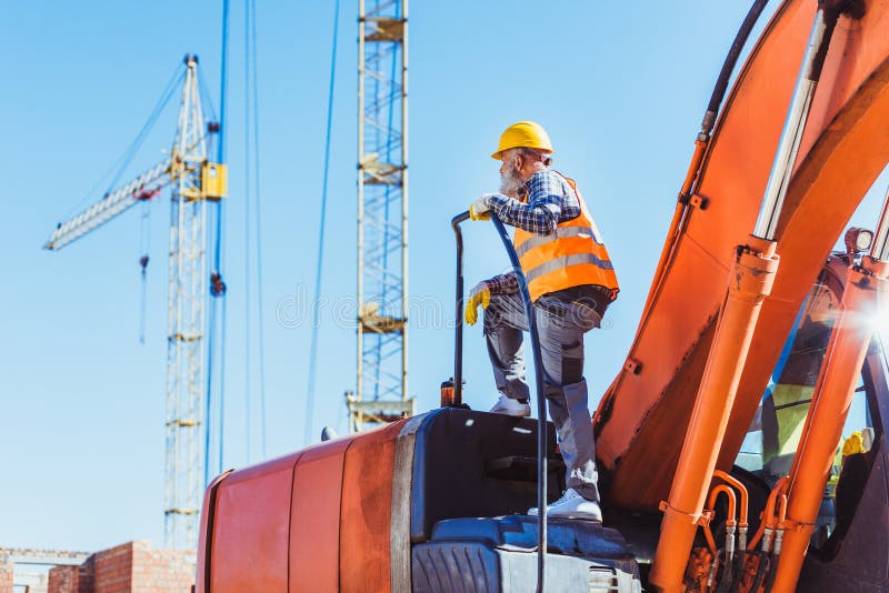 Construction Worker on Top of Excavator Cabin Stock Photo - Image of ...