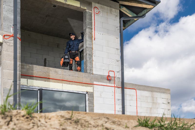 Construction Worker on Unfinished Building with Tool in Hand Stock ...
