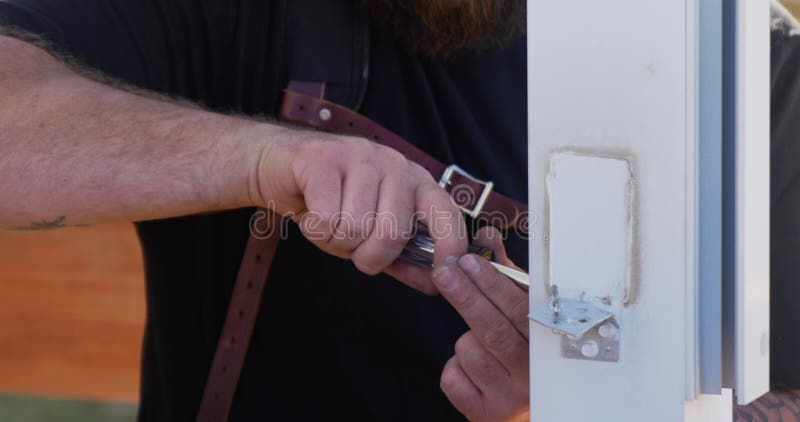 Construction Worker Unscrewing Bolt by Hand with a Handheld Screwdriver ...