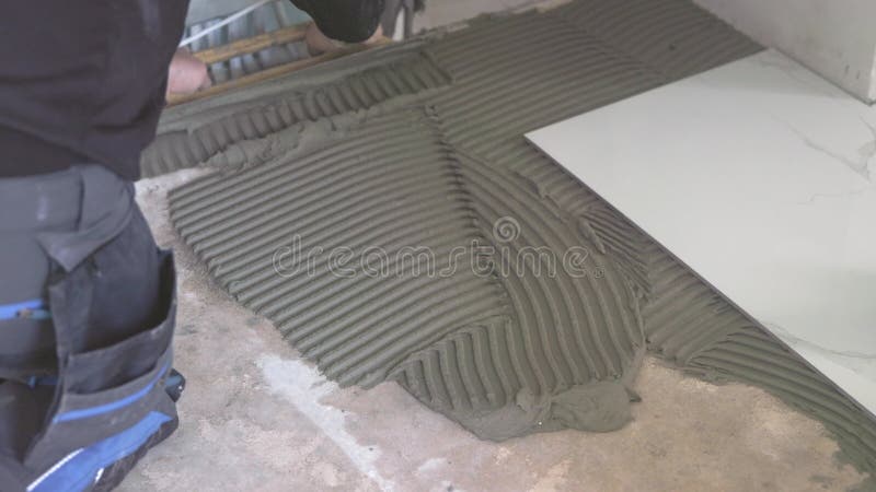Construction Worker Spreading Tile Adhesive on Floor Stock Footage ...