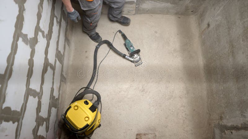 Construction Worker Using Angle Grinder and Vacuum Cleaner for Dust ...