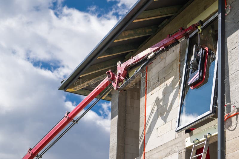 Construction Worker Using Boom Lift for Window Installation Stock Photo ...