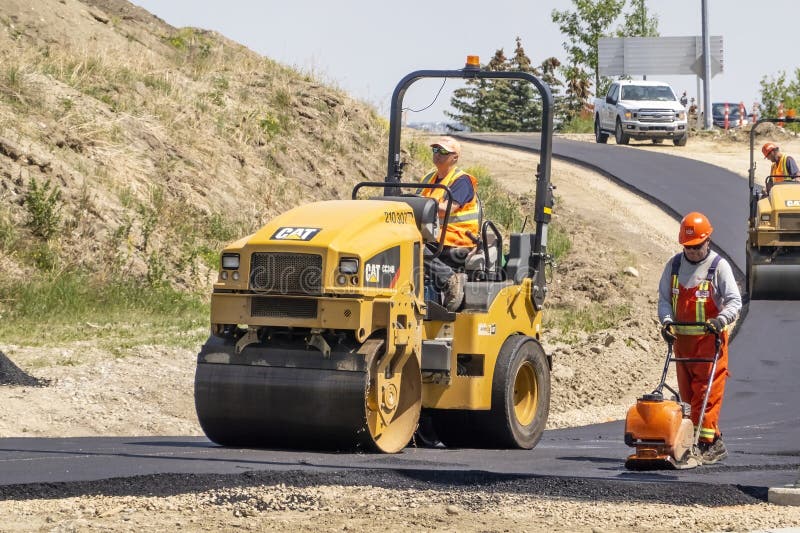 A Construction Worker Using a Cat Tandem Vibratory Roller. Use To ...