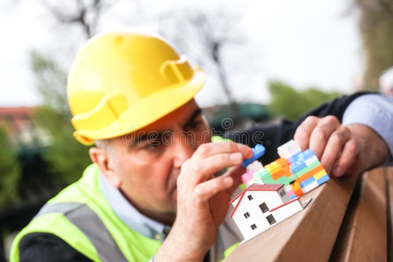 Construction Worker Using Colourful Toy Bricks Stock Photo - Image of ...