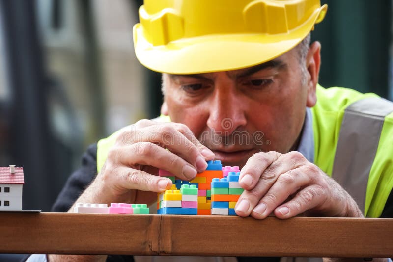 Construction Worker Using Colourful Toy Bricks Stock Photo - Image of ...