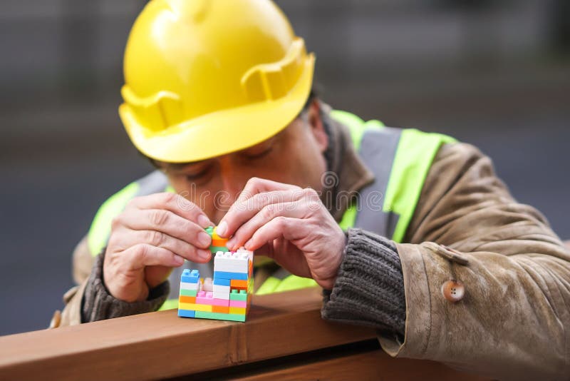 Construction Worker Using Colourful Toy Bricks Stock Image - Image of ...