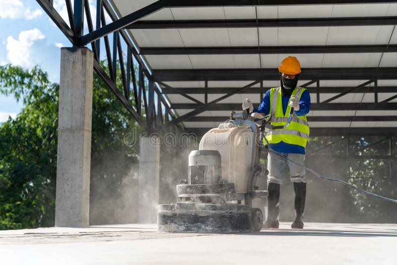 A Construction Worker Using Concrete Polishing Machine or Polishing ...