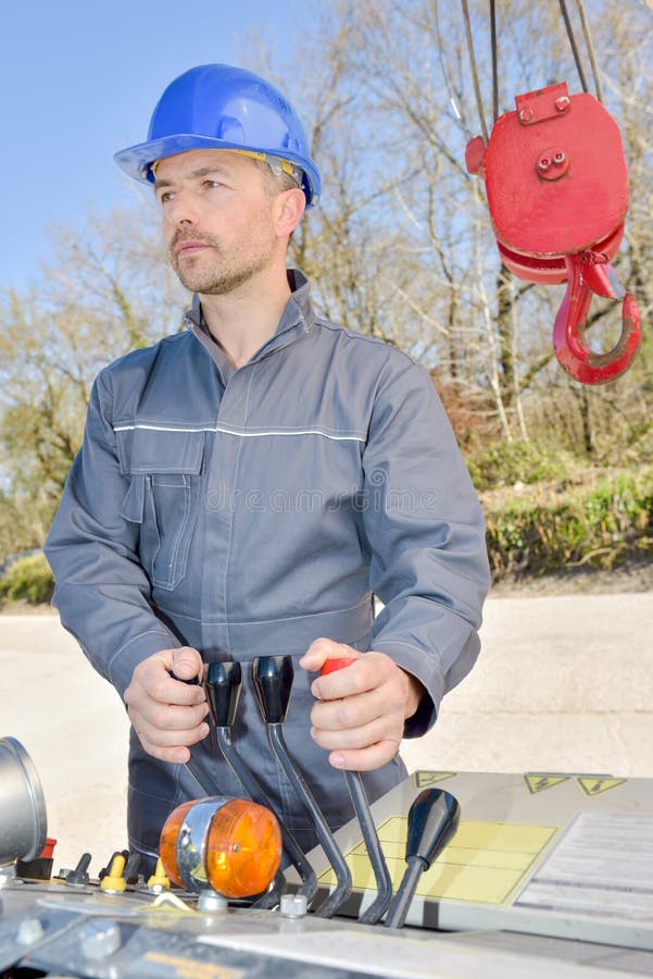 Construction Worker Using Crane at Building Site Stock Image - Image of ...