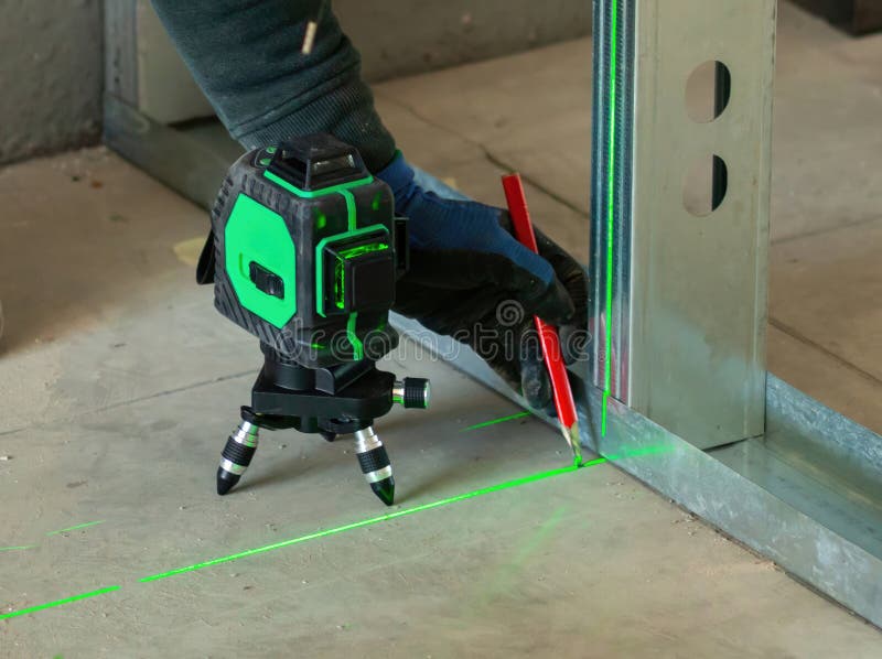 Construction Worker Using a Cross Line Laser Level during Finishing ...