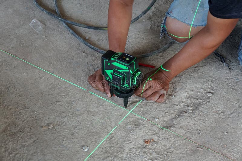Construction Worker is Using Cross-line Laser Level Meter with Line ...