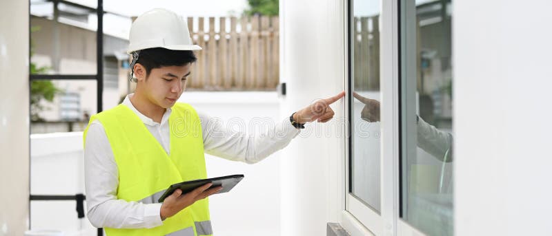 Construction Worker Using Digital Tablet with Check House Building ...
