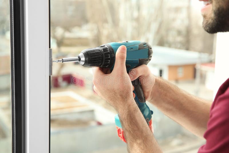 Construction Worker Using Drill while Installing Window Indoors Stock ...