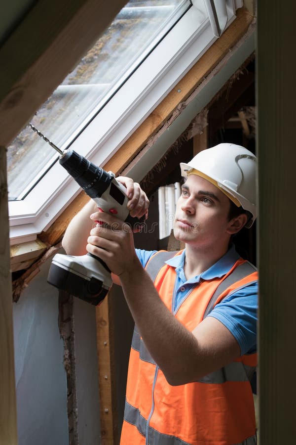 Construction Worker Using Drill To Install Replacement Window Stock ...