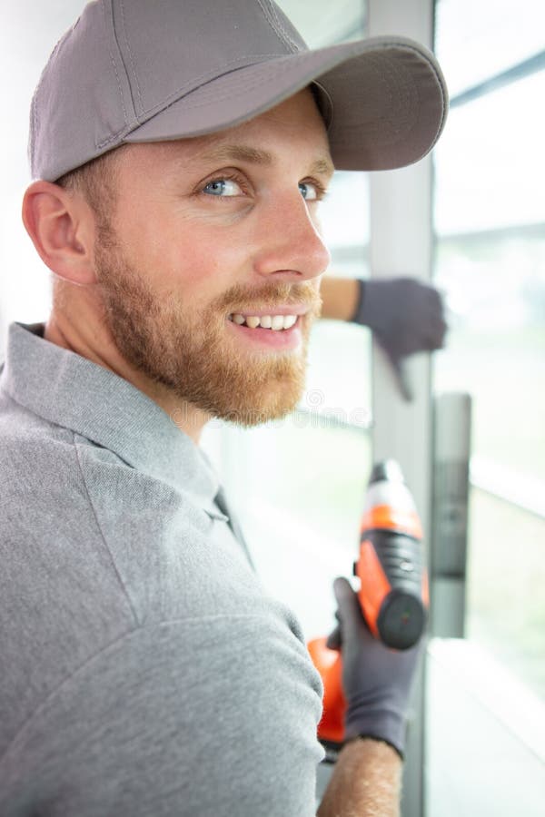 Construction Worker Using Drill To Install Window Stock Photo - Image ...