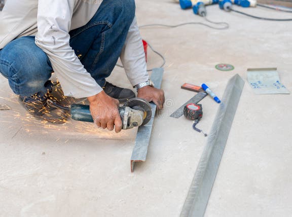 Construction Worker Using Electrical Angle Grinder for Cutting Angle ...