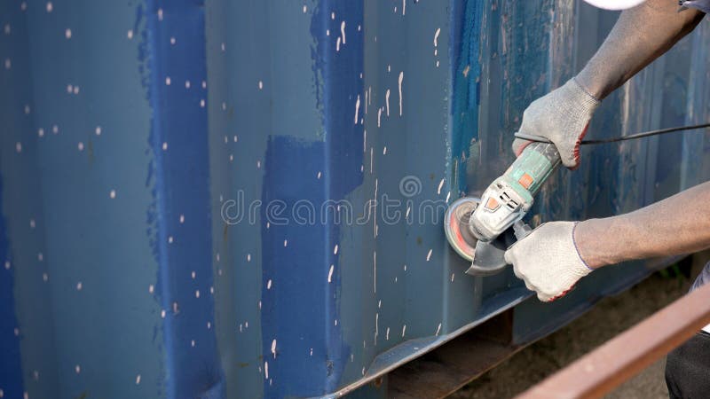 Construction Worker Removing Rust from Metal Surface Using Grinding ...