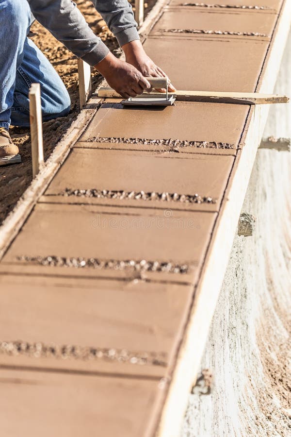 Construction Worker Using Hand Groover on Wet Cement Forming Coping ...
