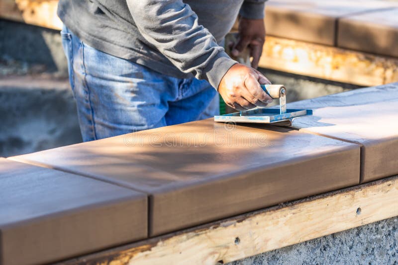 Construction Worker Using Hand Groover on Wet Cement Forming Coping ...