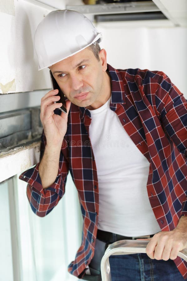 Construction Worker Using Mobile Phone Stock Photo - Image of looking ...