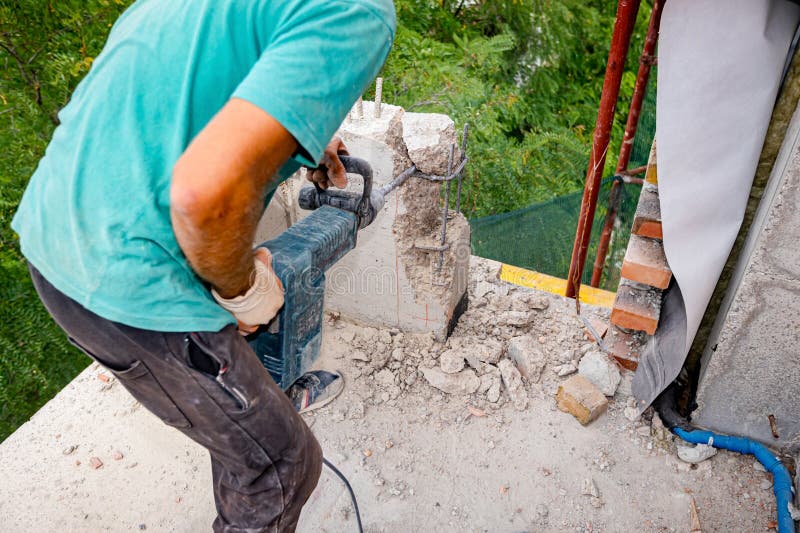 Construction Worker is Using Jackhammer To Break Reinforced Concrete ...
