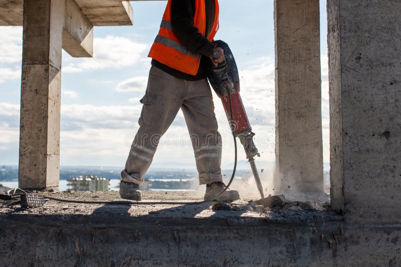 Construction Worker Using Jackhammer To Drill Concrete Floor. Stock ...