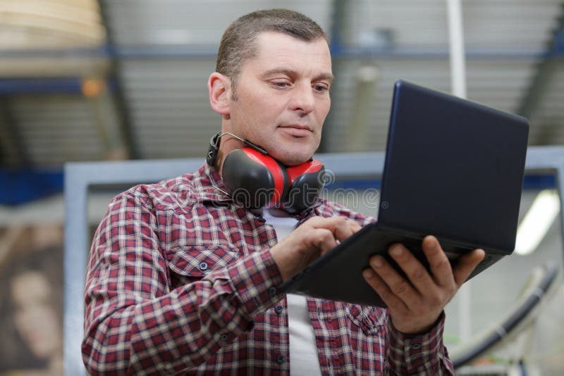 Construction Worker Using Laptop at Bulding Site Stock Image - Image of ...