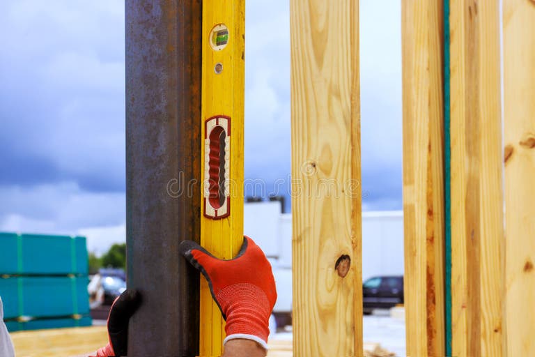 Construction Worker Using Level Tool To Ensure Vertical Alignment of ...