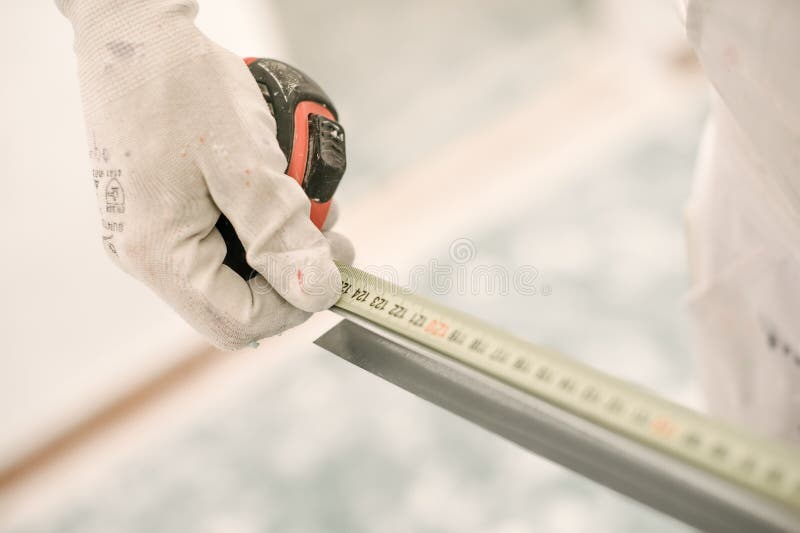 Construction Worker Using Measuring Tape Stock Photo - Image of closeup ...