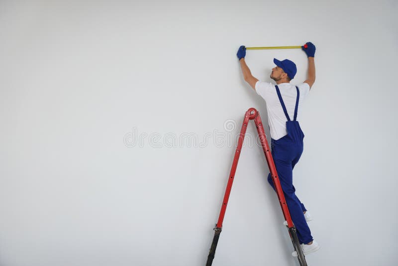 Construction Worker Using Measuring Tape Indoors. Room Renovation Stock ...