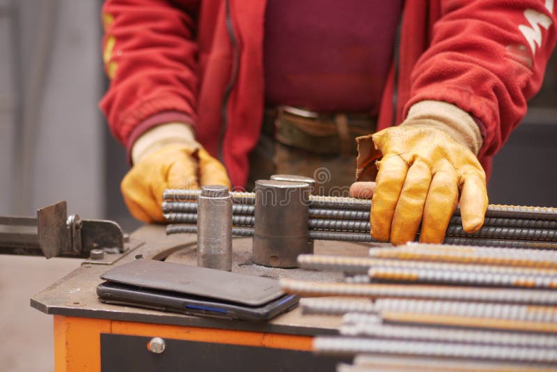 Construction Worker Using Metalwork Equipment on Steel Rods at Worksite ...