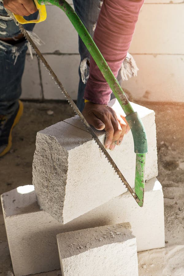 Construction Worker Using Saw for Cutting Bricks Stock Image - Image of ...