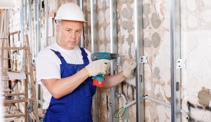 Construction Worker Using Gun for Aluminum Profile Mounting at Indoors ...