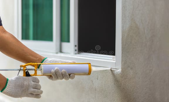 Construction Worker Using Silicone Sealant Caulk the Outside Window ...