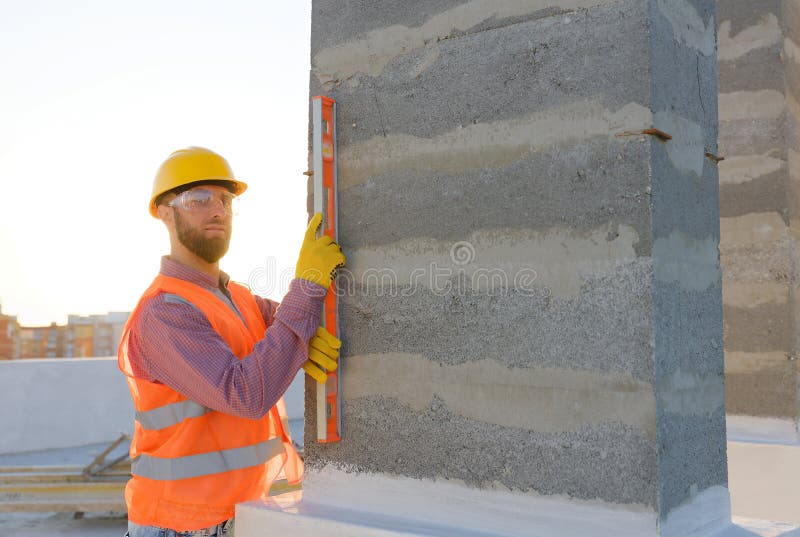 Construction Worker Using Spirit Level on Building Site at Sunset Stock ...