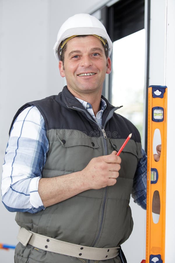 Construction Worker Using Spirit Level in New House Stock Photo - Image ...