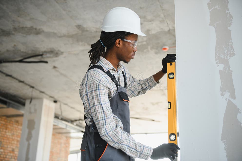 Construction Worker Using Spirit Level on Wall at Construction Site ...