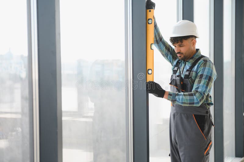 Construction Worker Using Spirit Level on Window Frame Stock Image ...