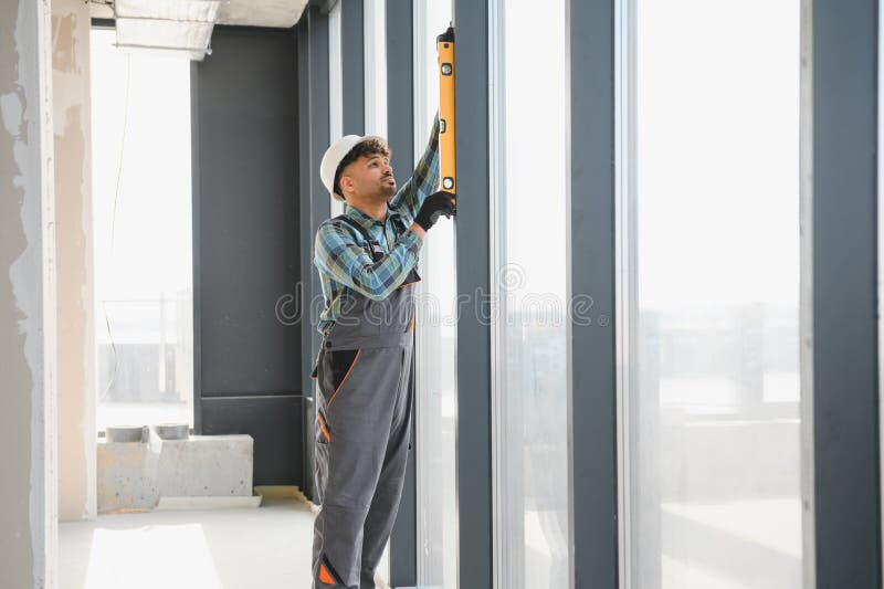 Construction Worker Using Spirit Level on Window Frame in Building ...